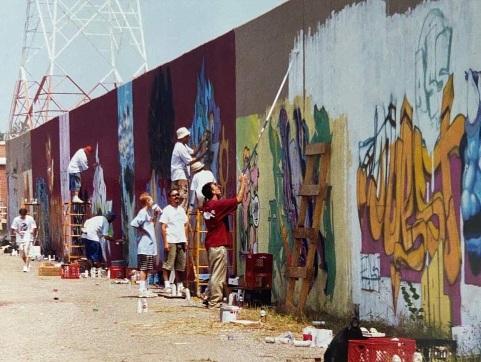 Paint Louis Returns For 26th Year Colorizing St. Louis Floodwall